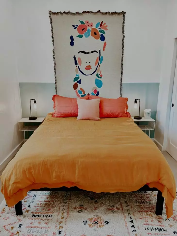 Bed with Frida Kahlo tapestry in head